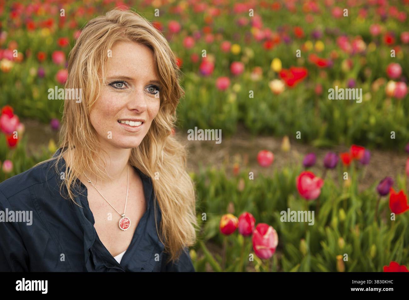 Portrait of a beautiful blond Dutch girl in tulips fields Stock Photo ...