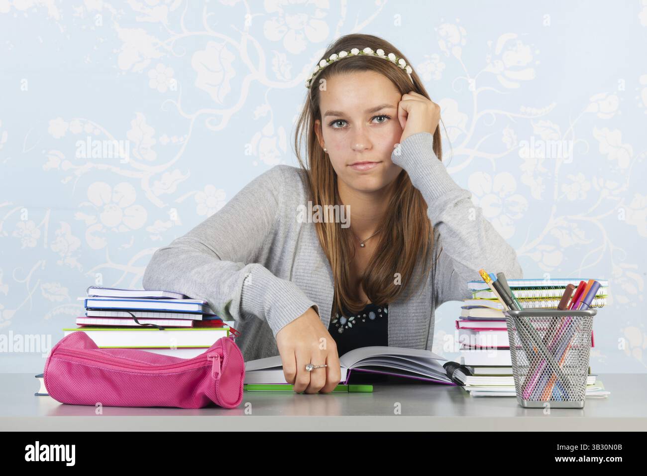 Teen girl sitting at desk with homework for school Stock Photo - Alamy
