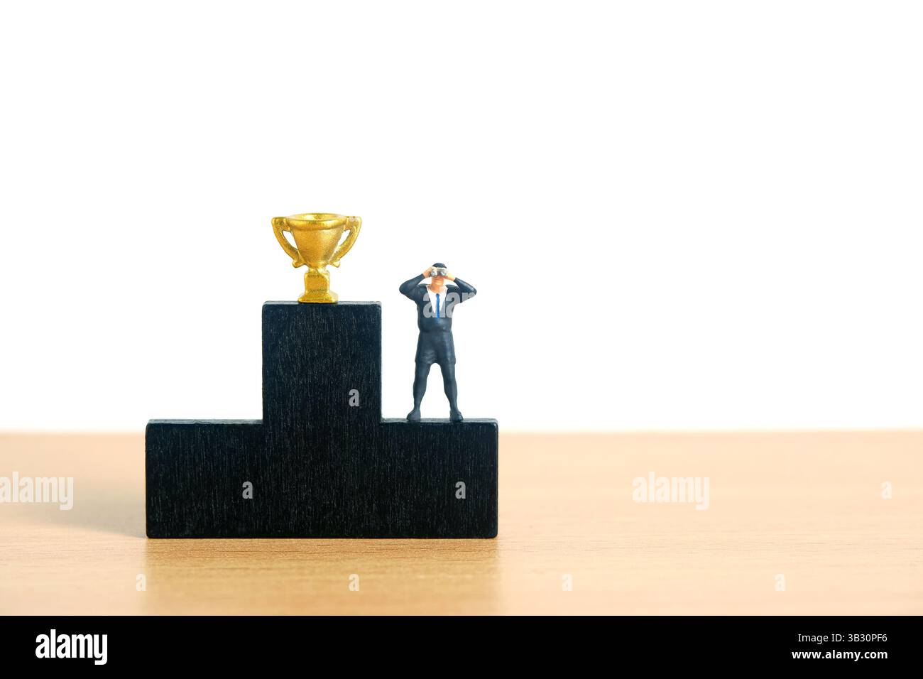 Businessmen standing using binoculars above black podium on desk with ...