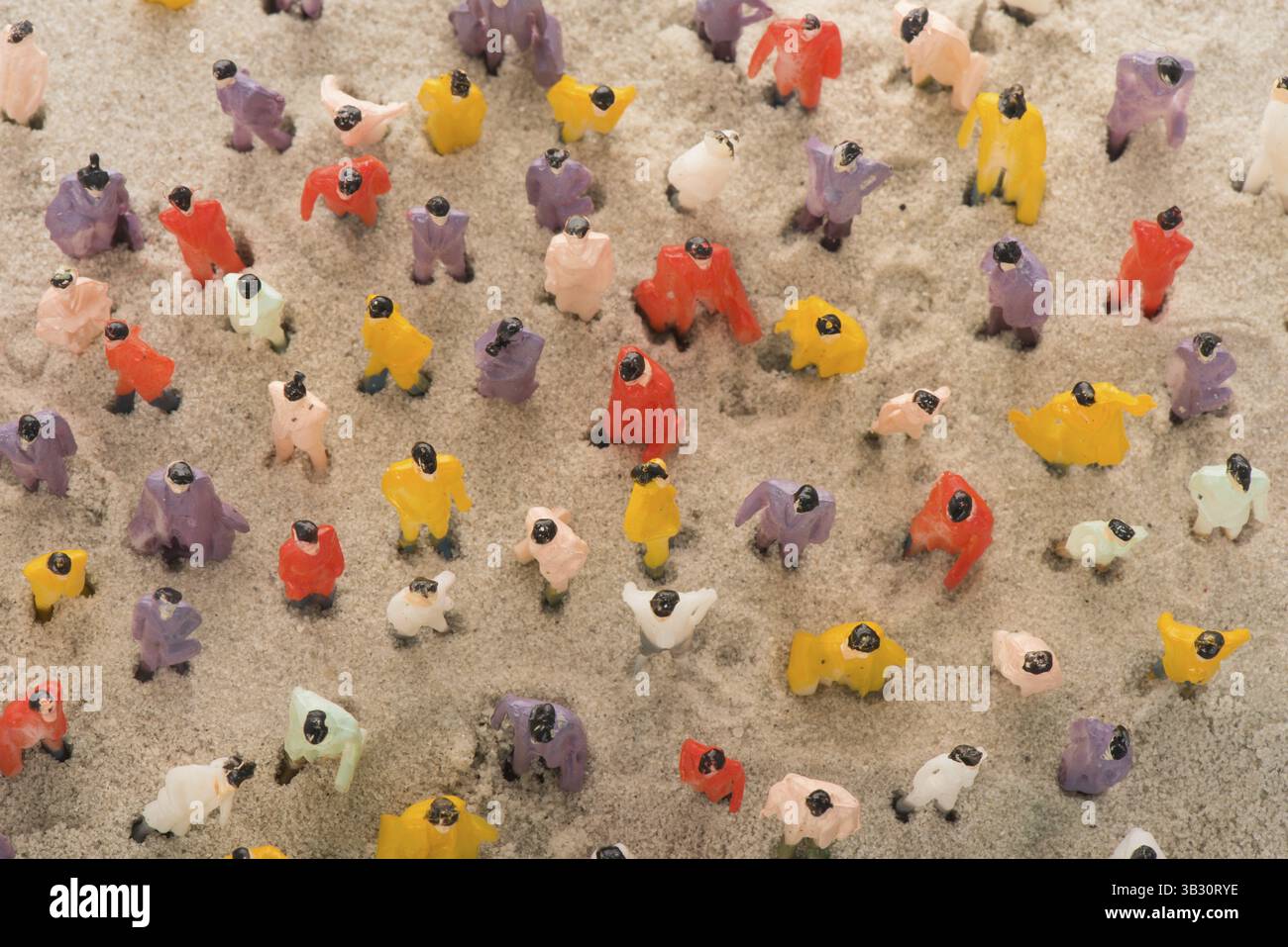People crowd standing in sand Stock Photo - Alamy
