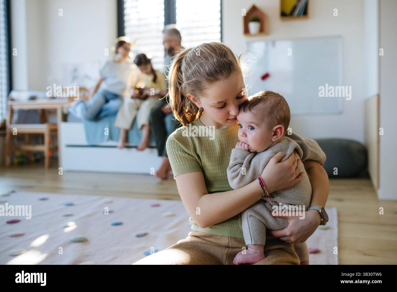 Big sister comforting sad baby brother Stock Photo - Alamy