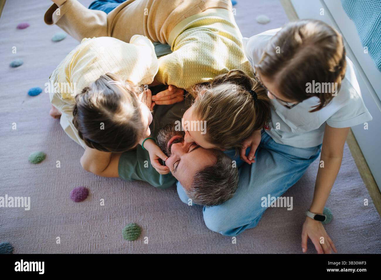 Portrait of father with three daughters at home Stock Photo - Alamy