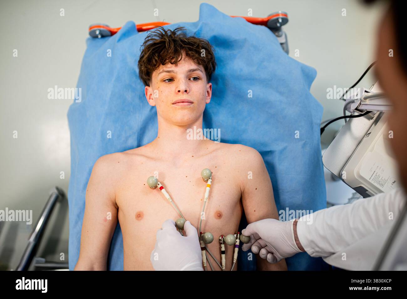 Preoperative EKG examination of teenage patient in hospital setting ...