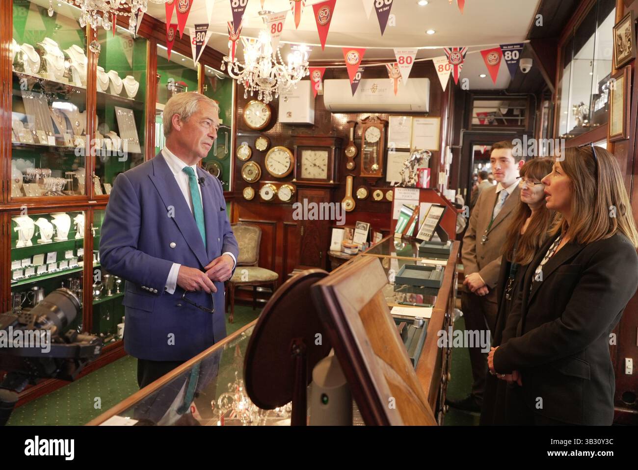 Reform UK leader Nigel Farage speaking to locals in a store in ...