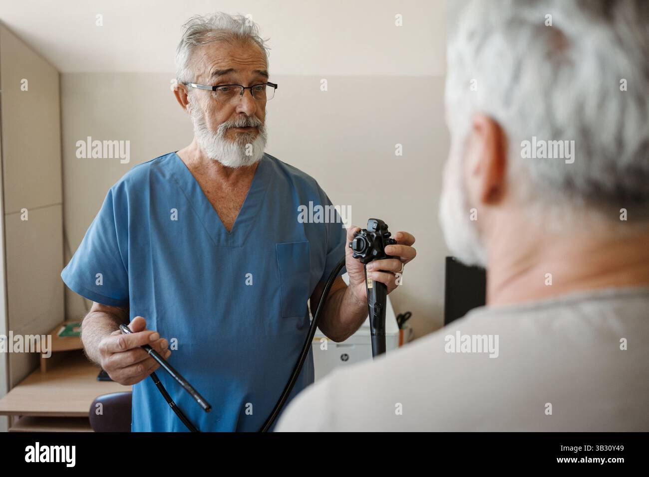 Doctor explaining gastroscopy procedure on patient. Examination of ...
