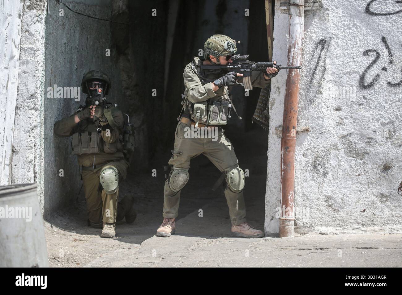 Israeli soldiers take positions during a raid on the Al-Ain refugee ...