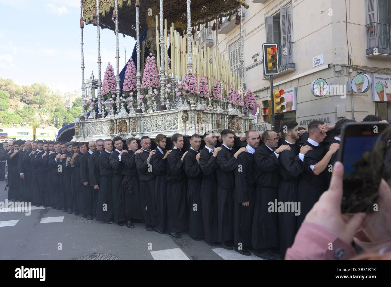 Good Friday procession, tourist photographed with smartphone ...