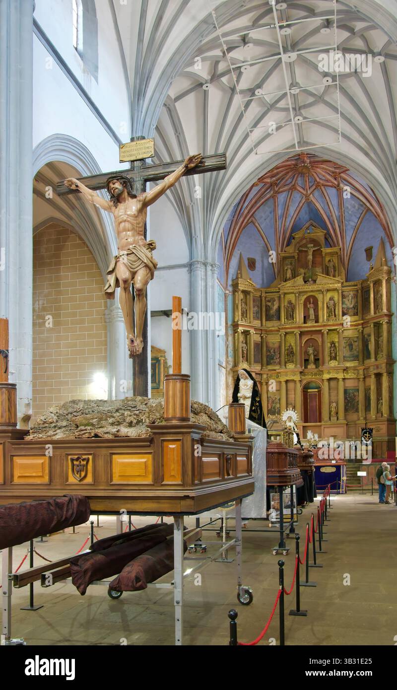 Paso with life-size wooden statue of Jesus Christ crucified on a wooden cross with the main ...