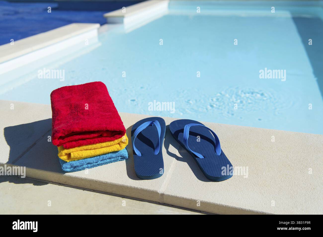 Flip flops and towels at the swimming pool Stock Photo - Alamy