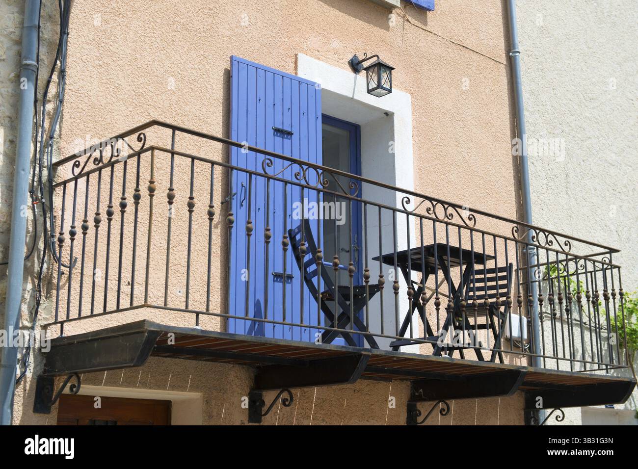 French balcony with blue shutters and furniture Stock Photo - Alamy