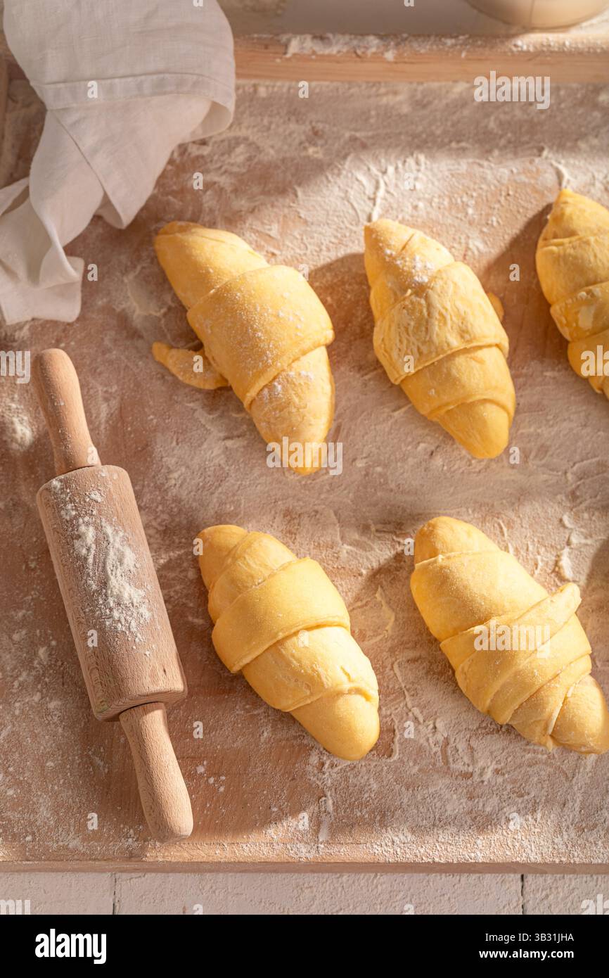 Traditionally french croissants cutting from raw dough Raw croissants ...