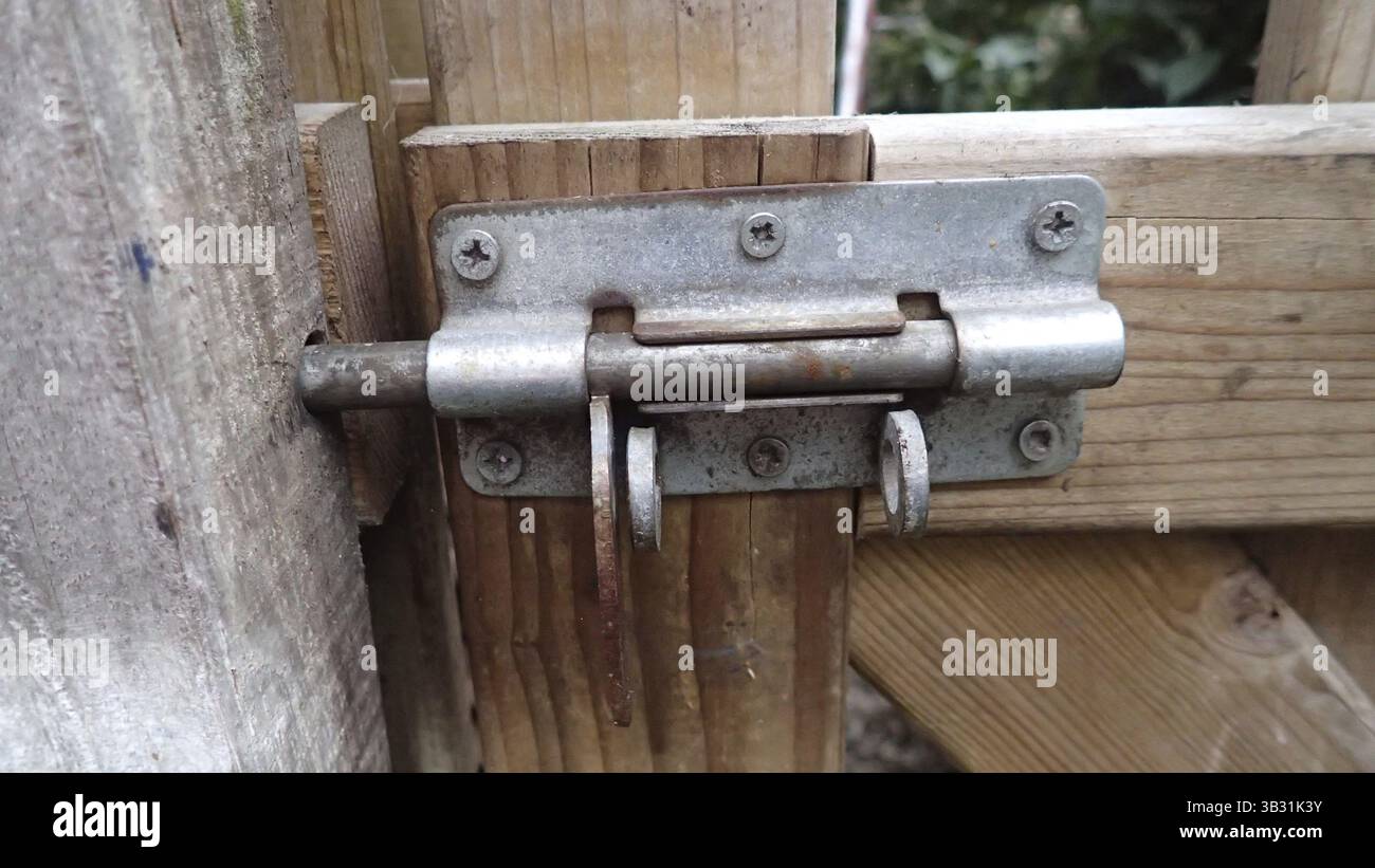 Metal lock on wooden fence outdoor Stock Photo - Alamy