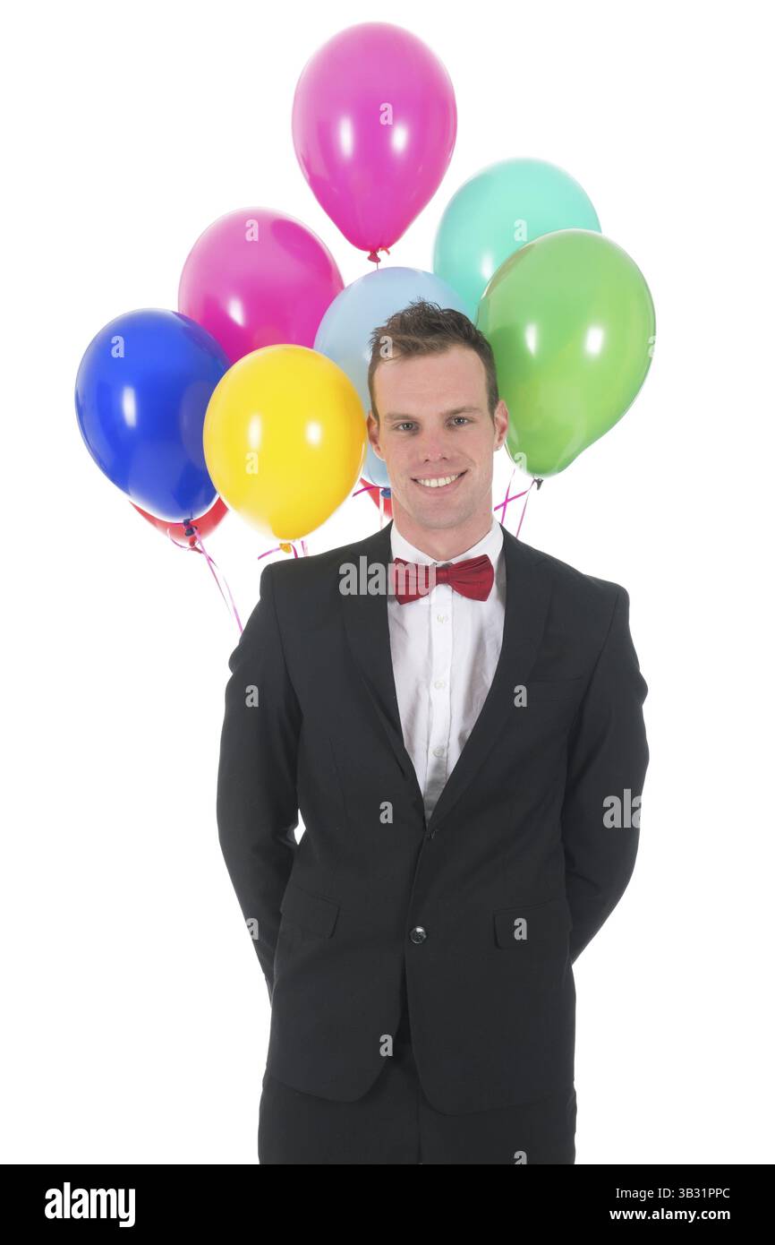 Young man with a bunch of colorful balloons isolated over white ...