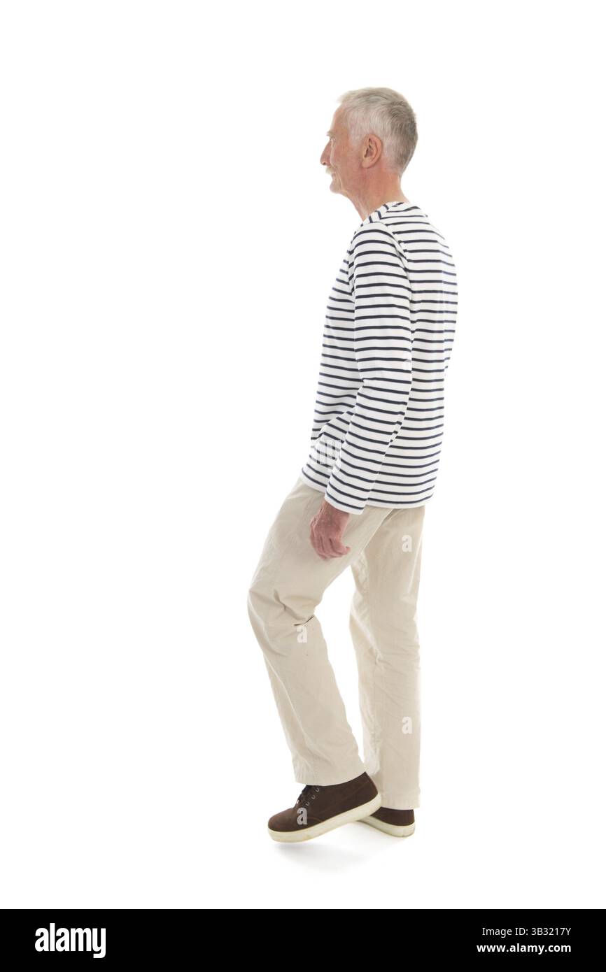 Senior man walking with full body in studio isolated over white ...