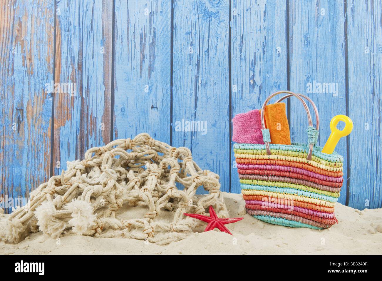 Colorful beach bag with toys at the beach Stock Photo - Alamy