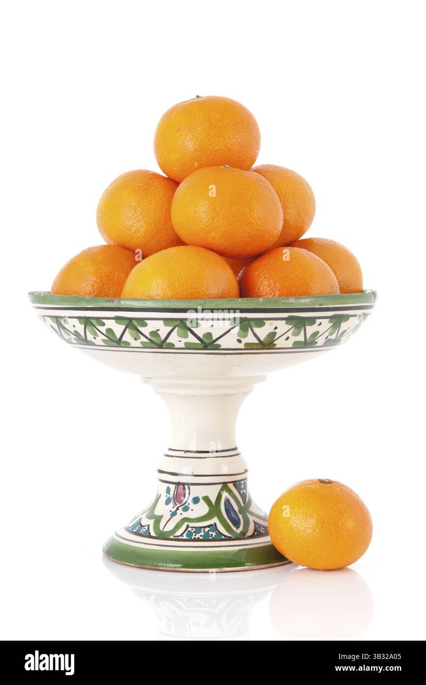 Stacked tangerines in bowl isolated over white background Stock Photo ...
