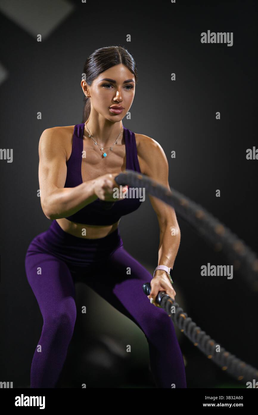 woman in purple workout outfit engages in high intensity fitness ...