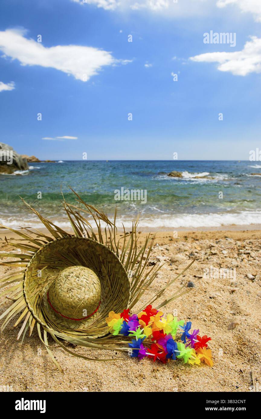 Straw sun hat and flower garland at the tropical beach Stock Photo - Alamy