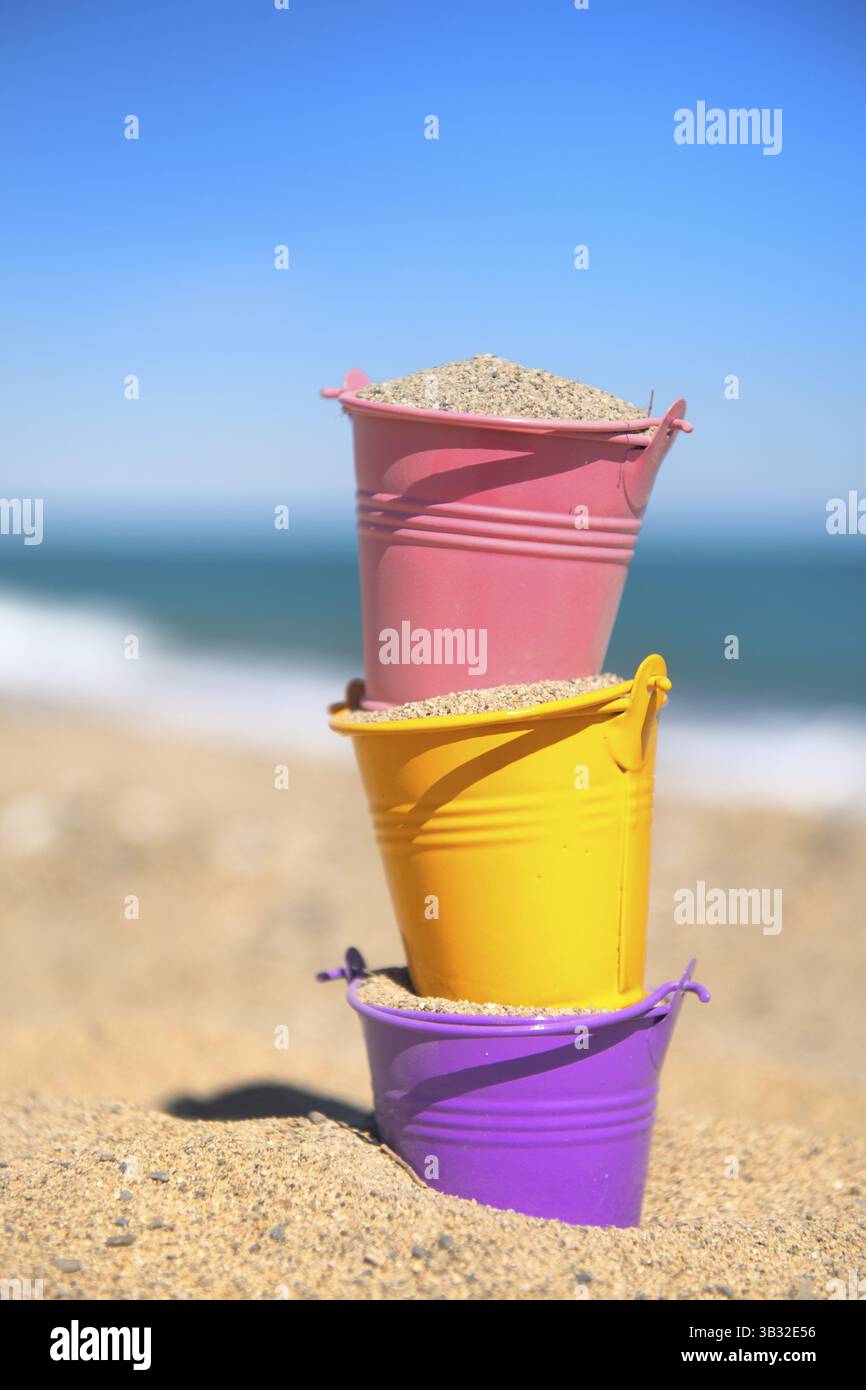 Colorful toy buckets at the beach Stock Photo - Alamy