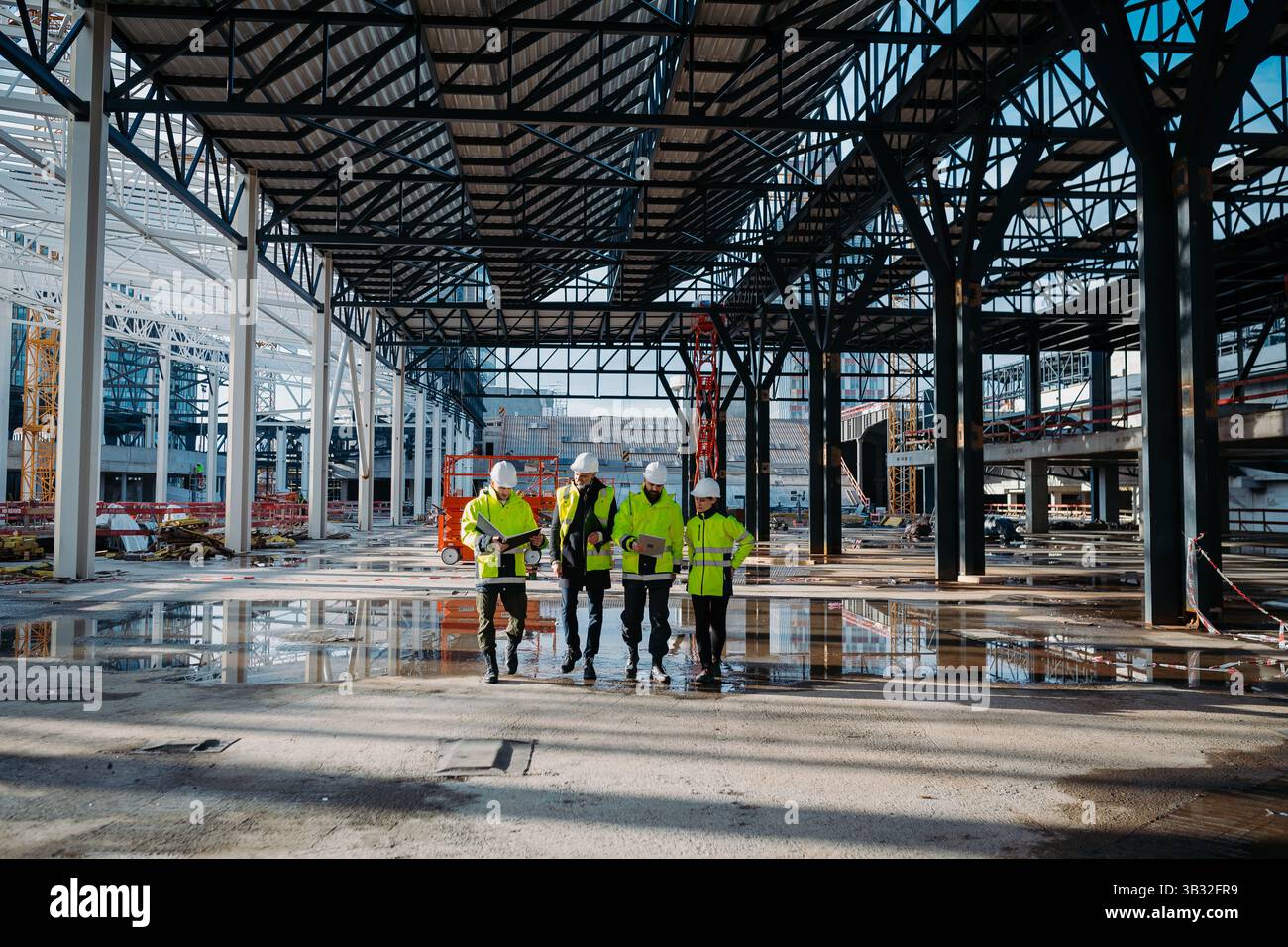 Team of engineers and construction workers inspecting building progress Stock Photo - Alamy