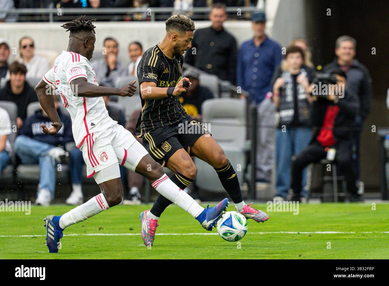 LAFC forward Denis Bouanga (99) is defended by St. Louis City SC ...