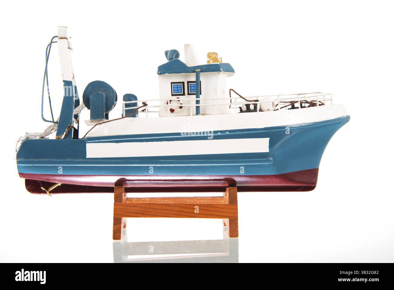 Miniature blue fishing trawler isolated over white background Stock ...