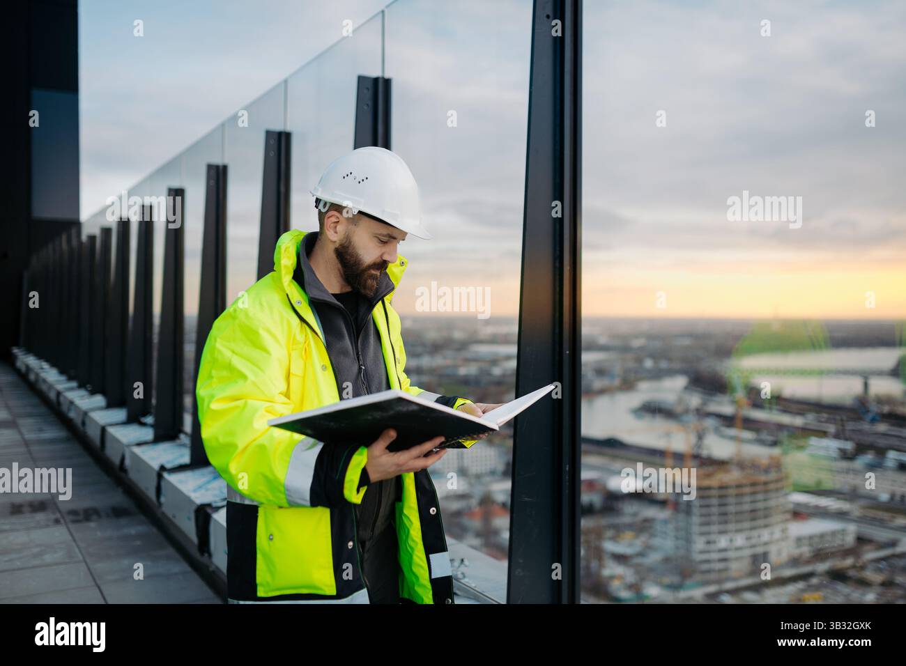 Engineer overseeing city construction project with blueprints in hand ...