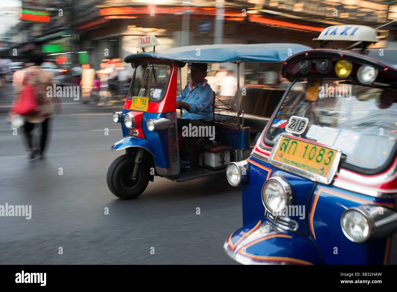 Dec 4, 2015 - Bangkok, Thailand - Tuk tuks taxi in the street. View down Thanon Yaowarat road at ...