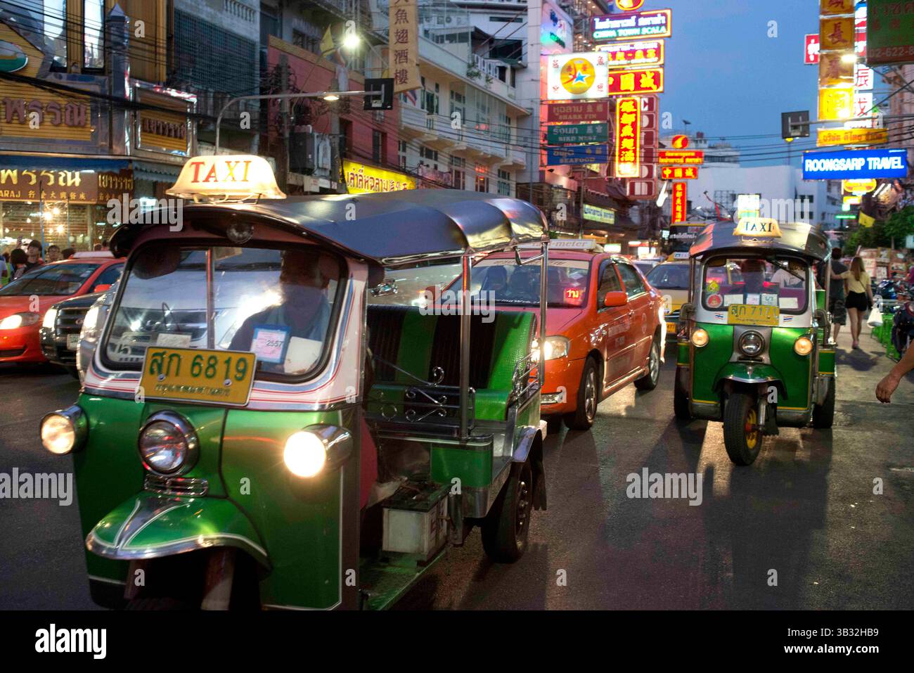 Dec 4, 2015 - Bangkok, Thailand - Tuk tuks taxi in the street. View down Thanon Yaowarat road at ...