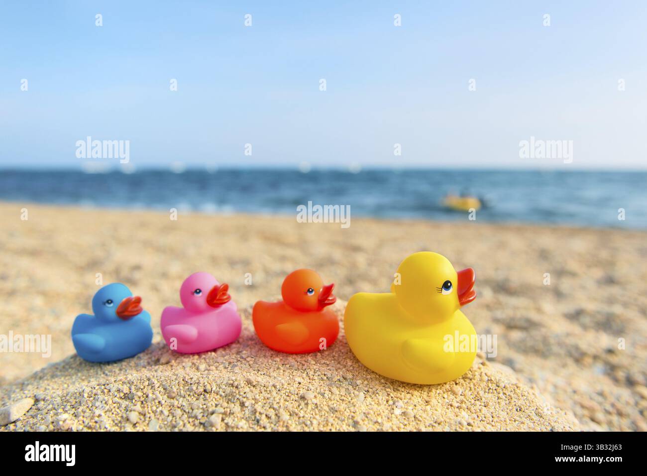 Colorful toy rubber ducks at the beach Stock Photo - Alamy
