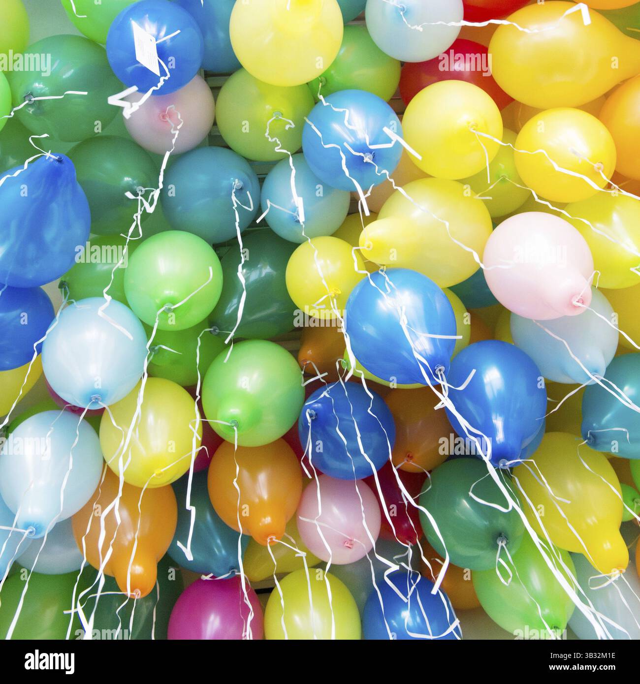 Many colorful balloons with ribbons Stock Photo - Alamy