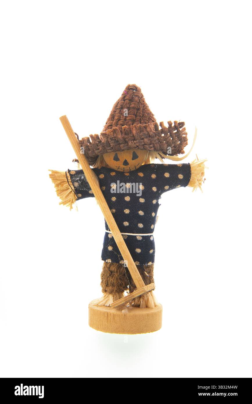Miniature scarecrow isolated over white background Stock Photo - Alamy