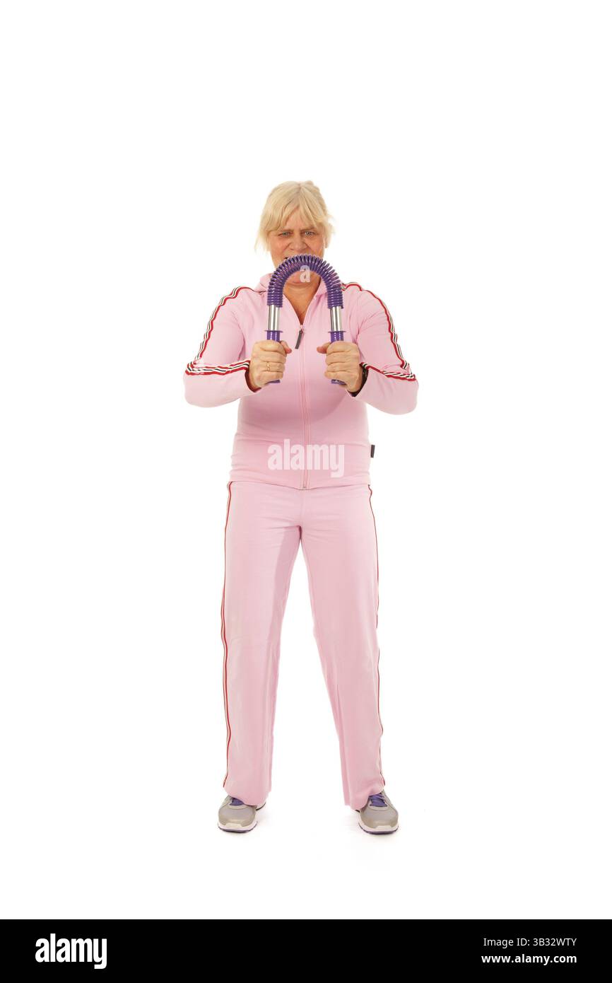 Senior woman bending heavy feather Stock Photo - Alamy