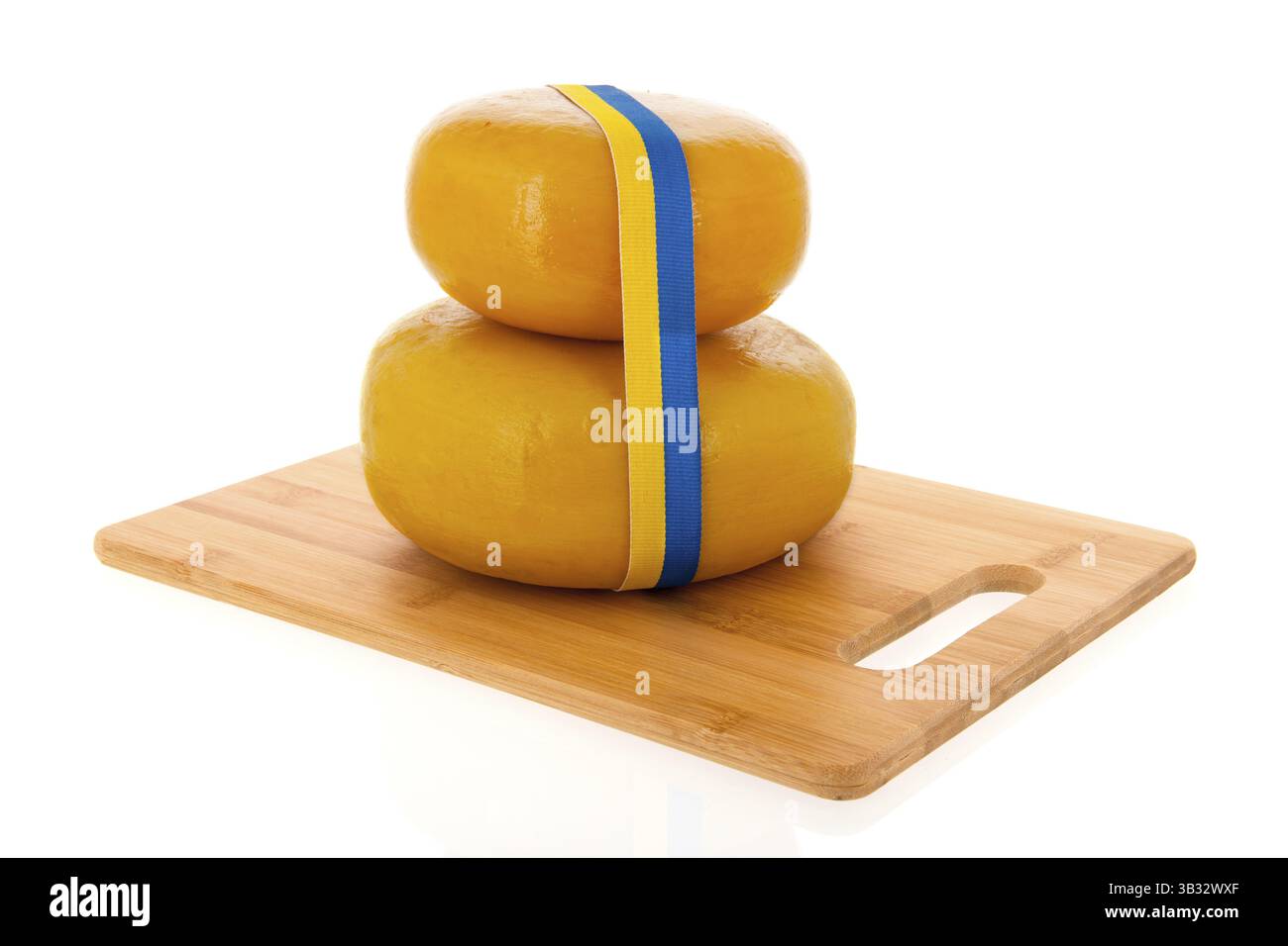 Two whole Swedish cheeses on wooden cutting board Stock Photo - Alamy