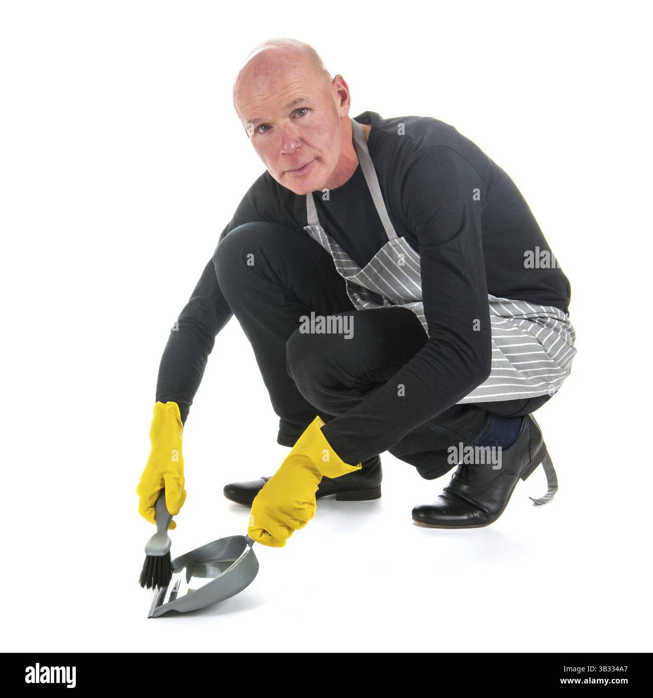 Working houseman with dustpan and brush isolated over white background ...