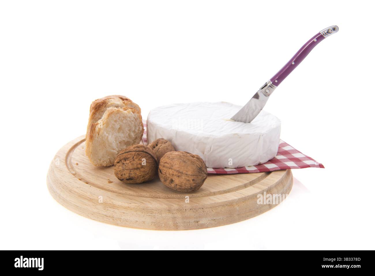 French Camembert cheese, bread and walnuts isolated over white ...