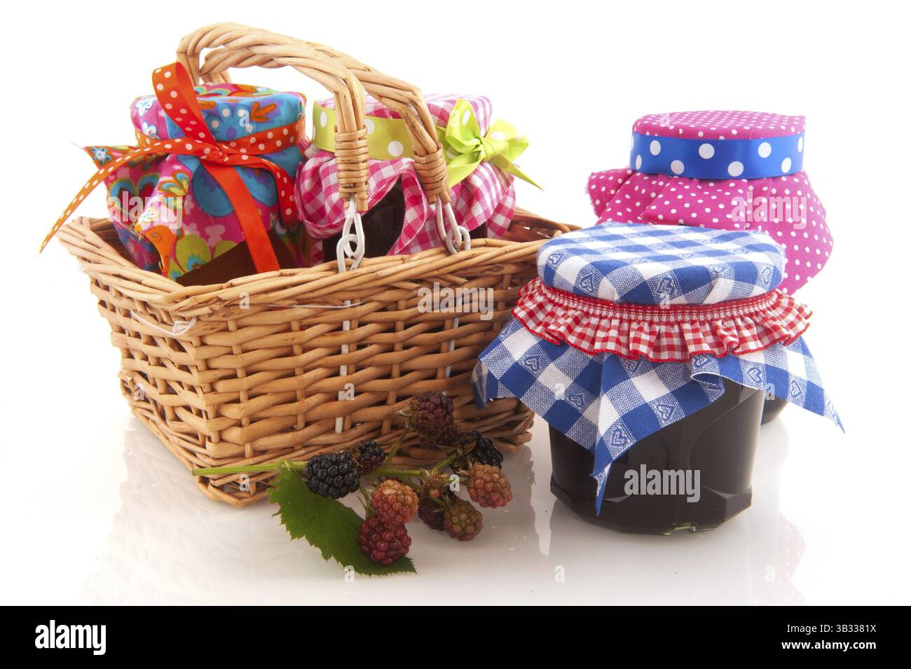 Many glass pots of homemade fruit jam in cane basket Stock Photo - Alamy