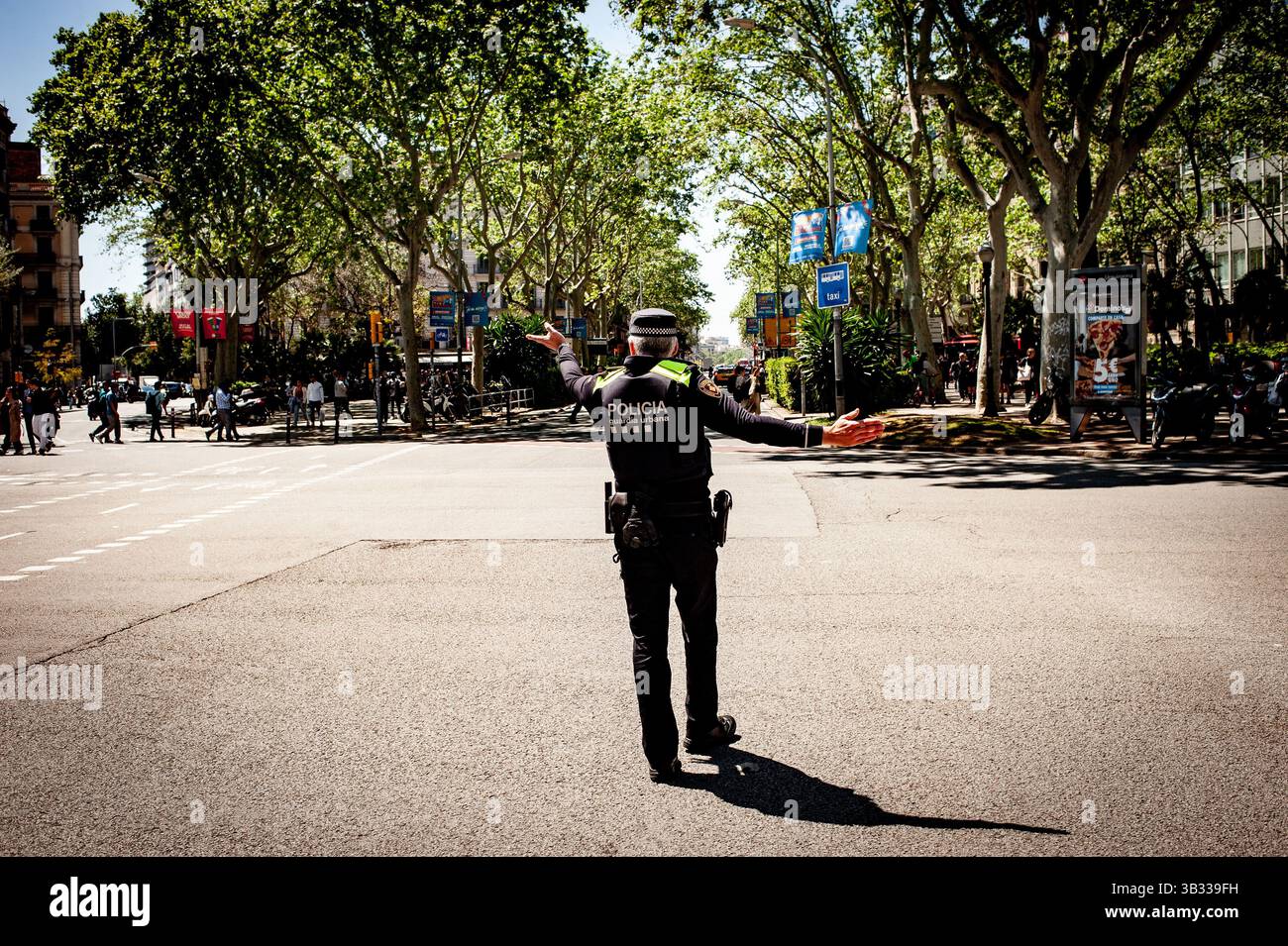 Barcelona, Spain. April 28, 2025, Barcelona, Spain: A police officer directs traffic in ...