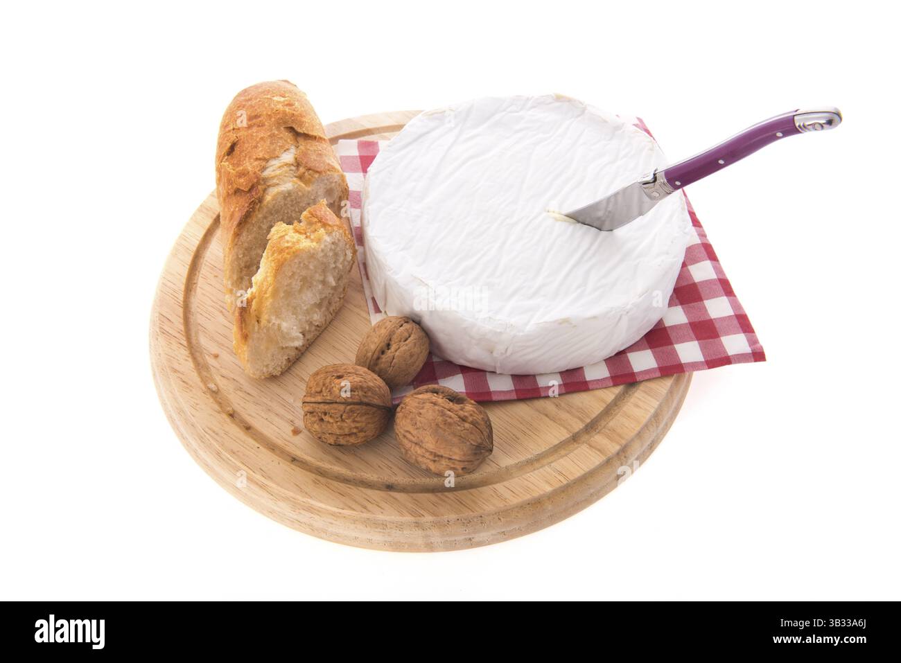 French Camembert cheese, bread and walnuts isolated over white ...