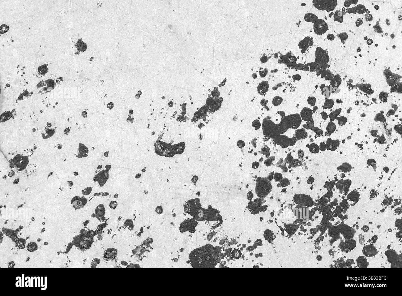 High-contrast black paint splatter texture on a gray concrete ...