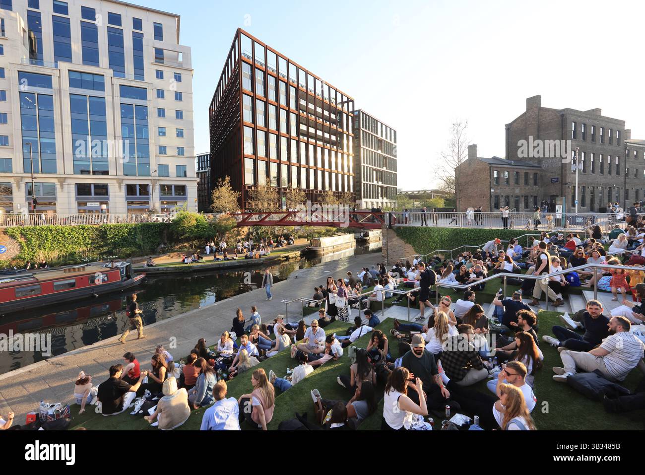 People on the steps by Regents Canal on Granary Square, enjoying spring ...