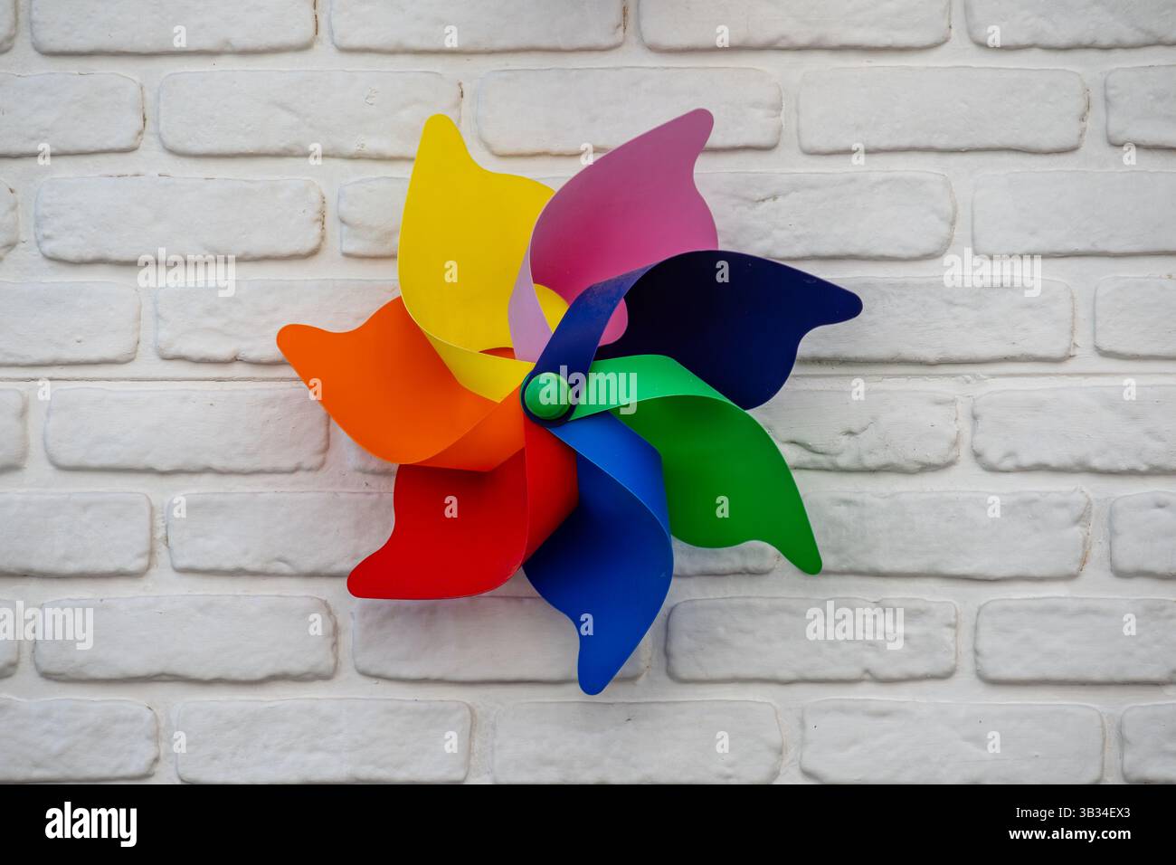 pinwheel with six vibrant blades—red, orange, yellow, pink, purple ...