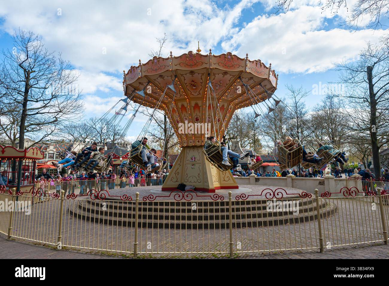 Children spin around in a carousel at Anton Pieck Square in amusement ...