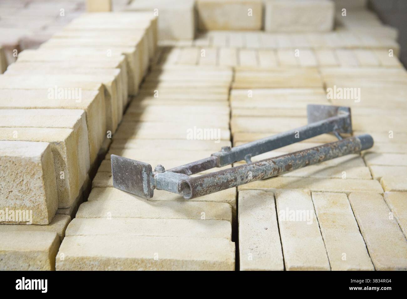 Stone bricks and scaffolding to build a house or wall Stock Photo - Alamy