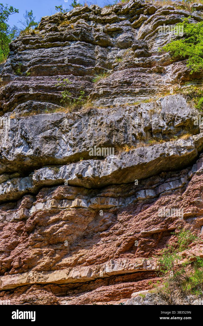 Layers of vibrant sedimentary rock rise majestically along the Boljetin ...