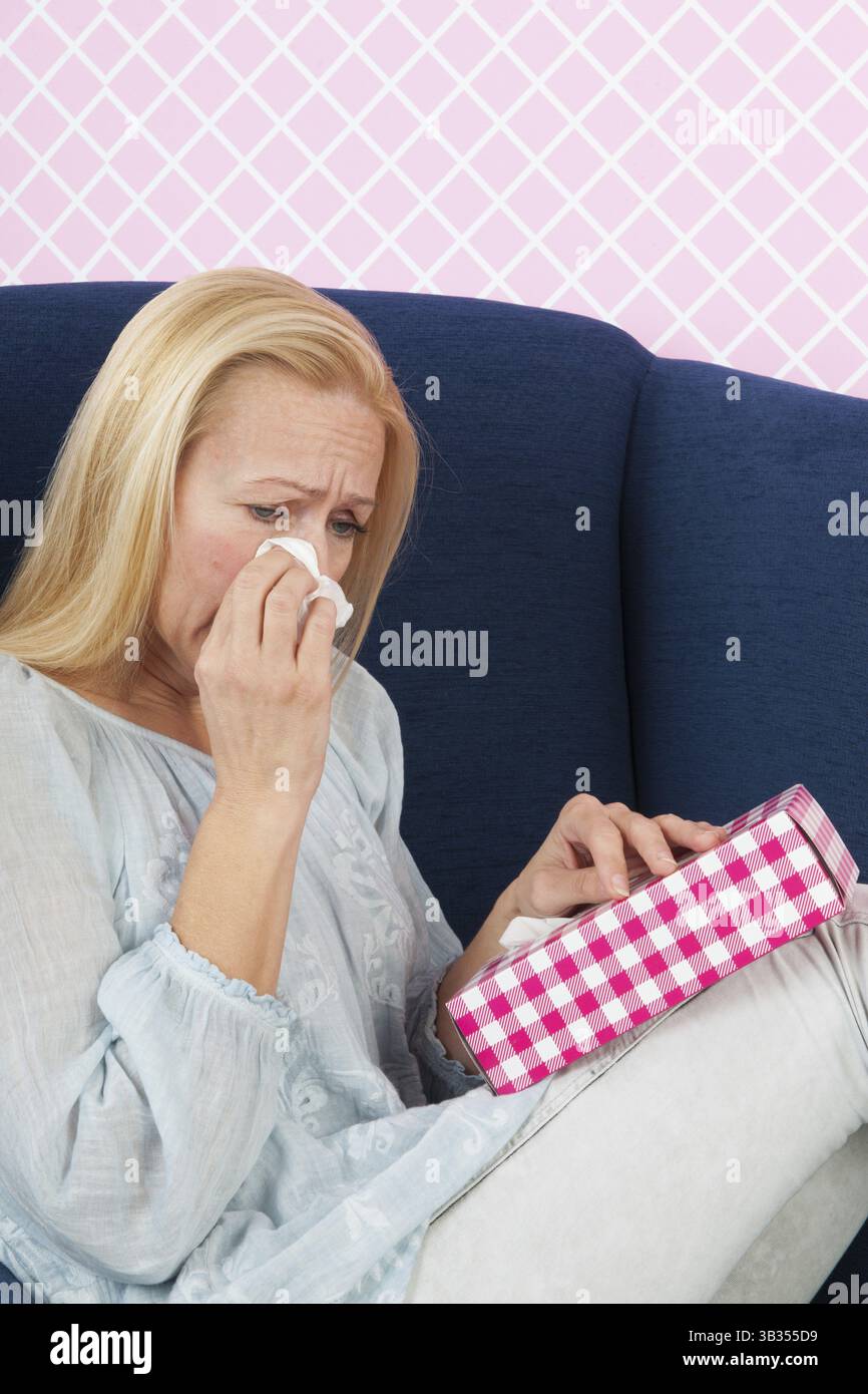 Woman in living room crying Stock Photo - Alamy