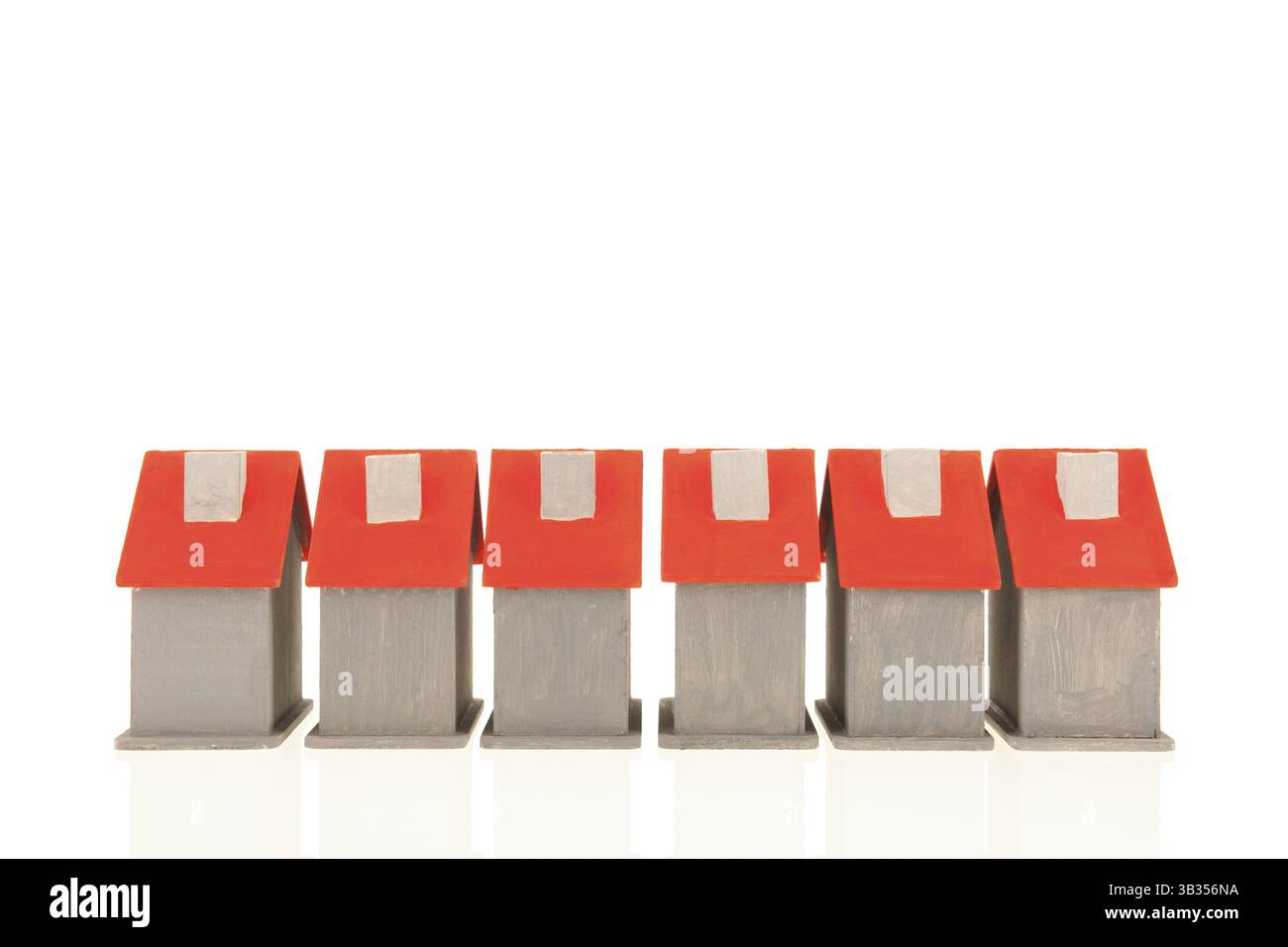 Row wooden houses same in gray and red isolated over white background ...