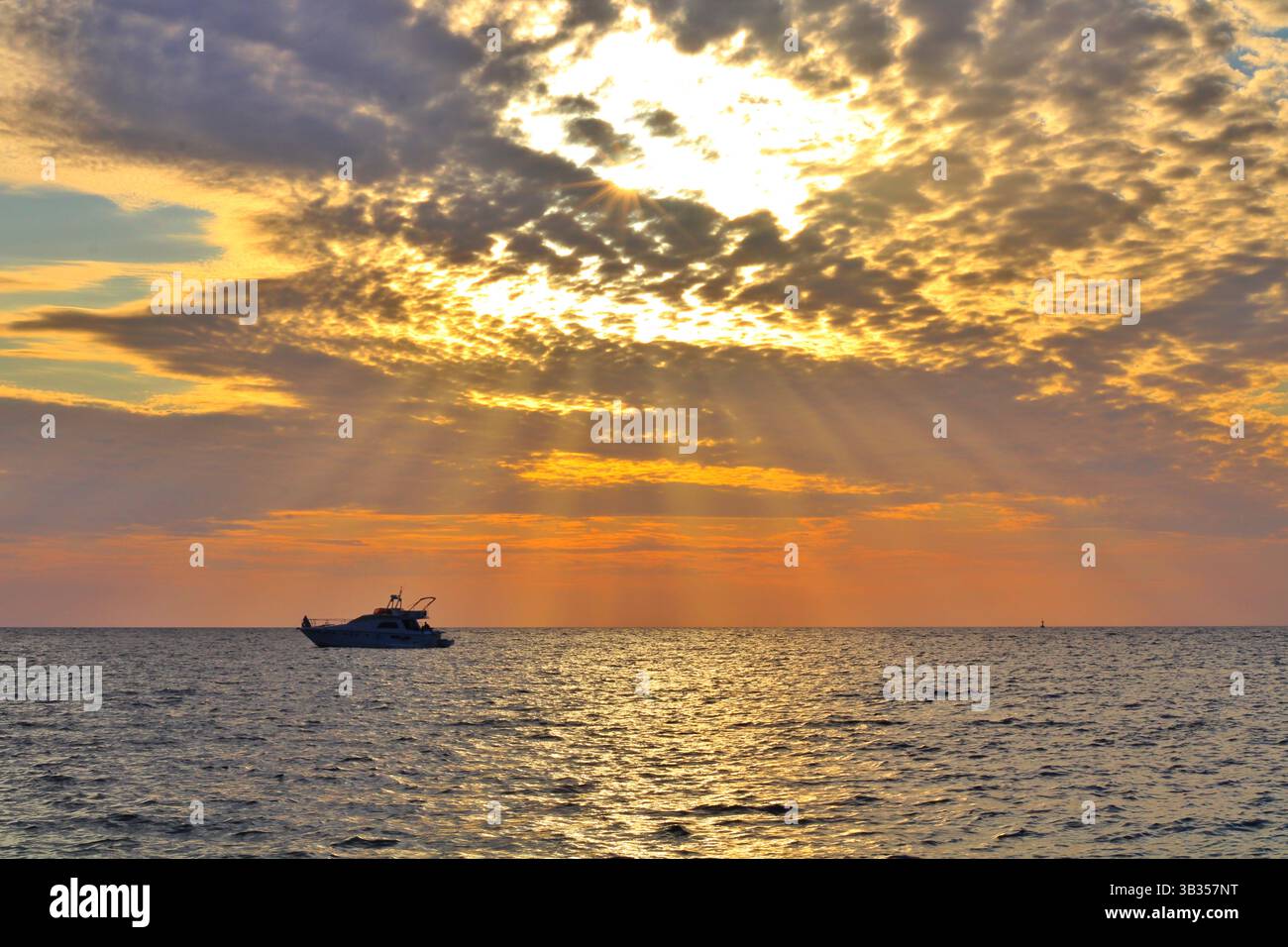 Sunset over boat on sea hi-res stock photography and images - Alamy