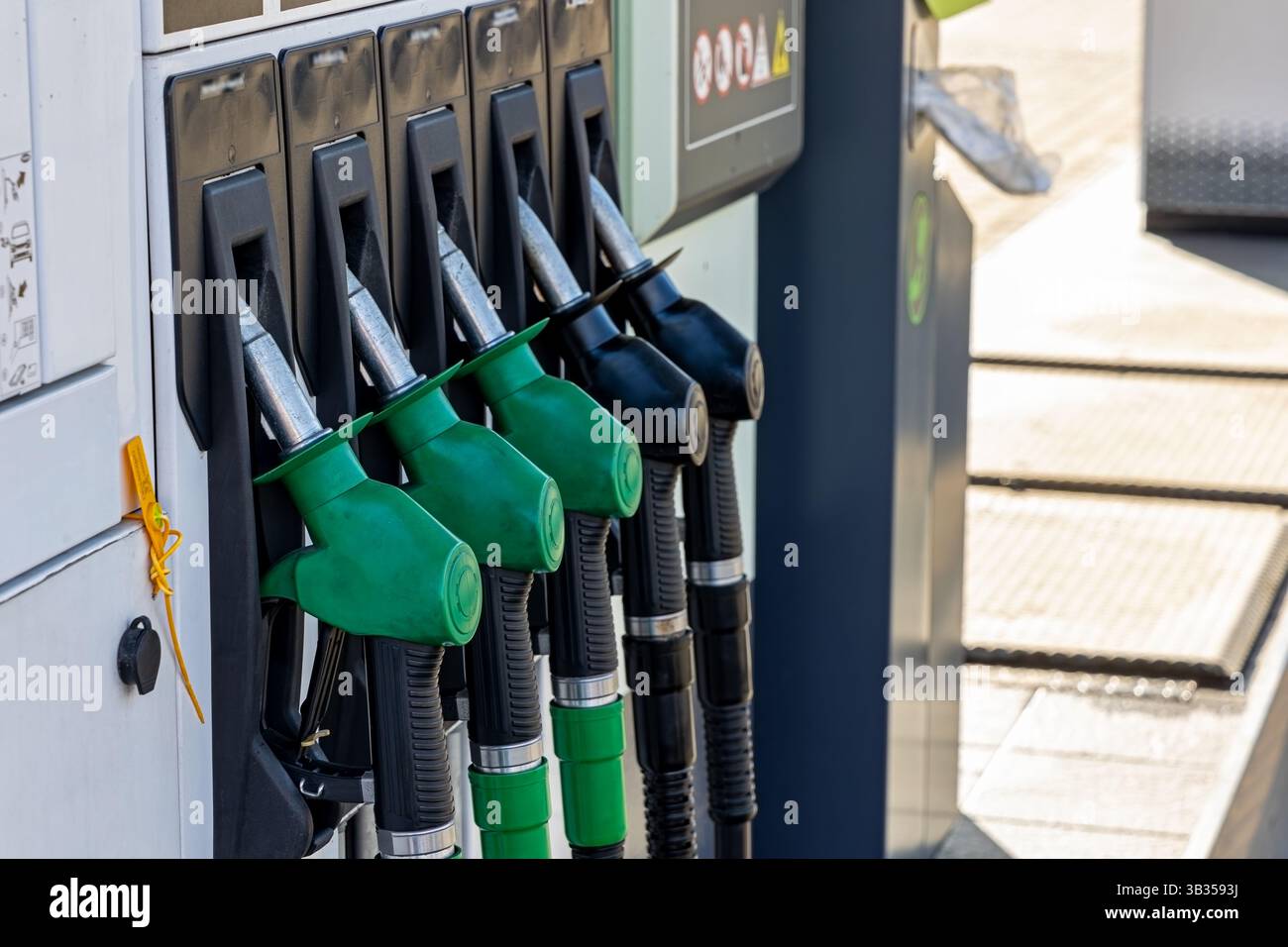 Close-up of fuel pump nozzles at gas station. Detailed view of multiple ...