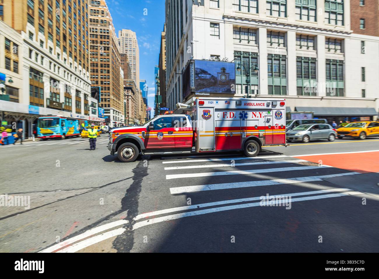 FDNY ambulance driving through busy New York City 34th street with high ...